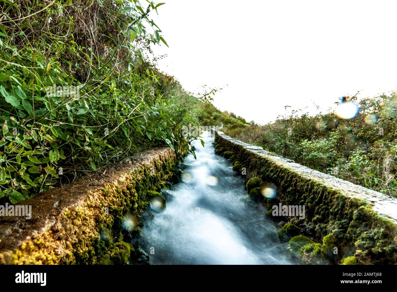 stone water channel full of running water in Tierra del Trigo village ...