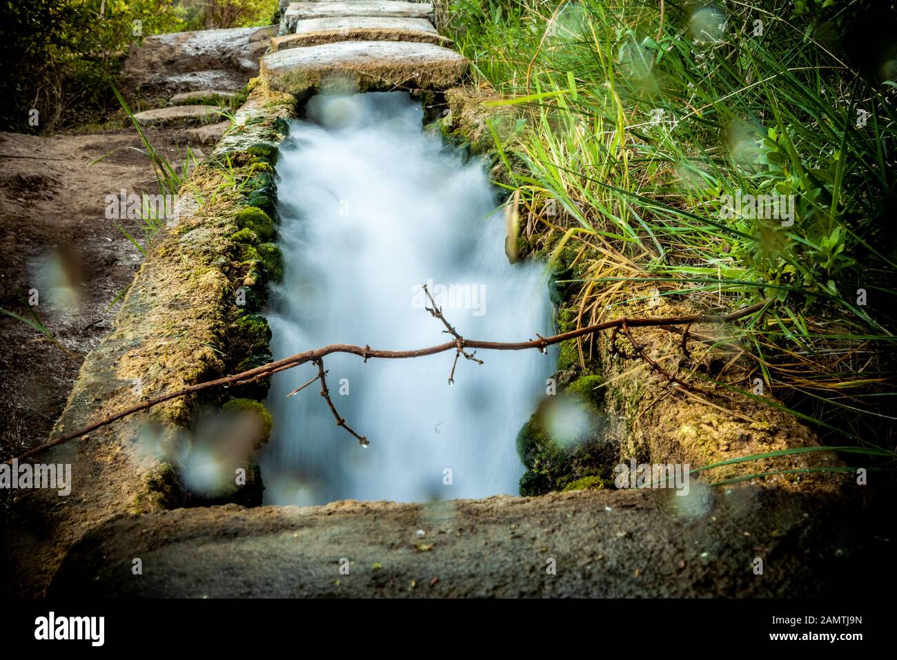 stone water channel full of running water in Tierra del Trigo village ...