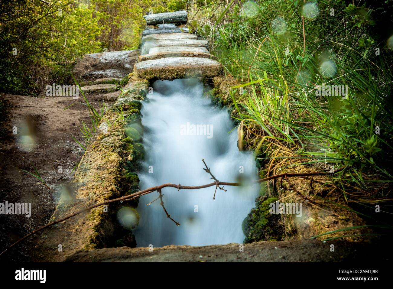 stone water channel full of running water in Tierra del Trigo village ...