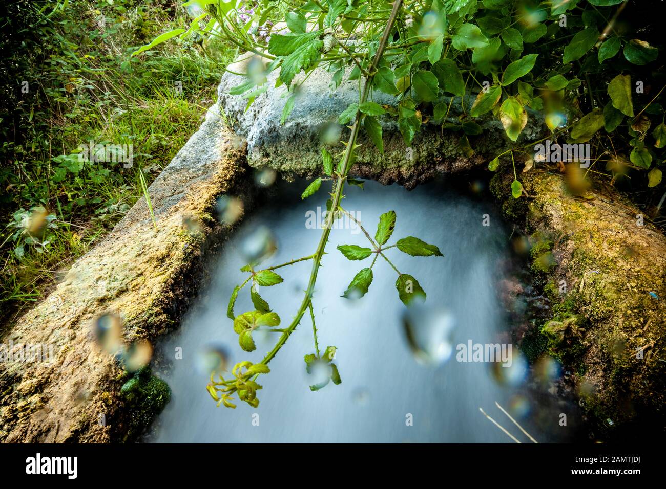 stone water channel full of running water in Tierra del Trigo village ...
