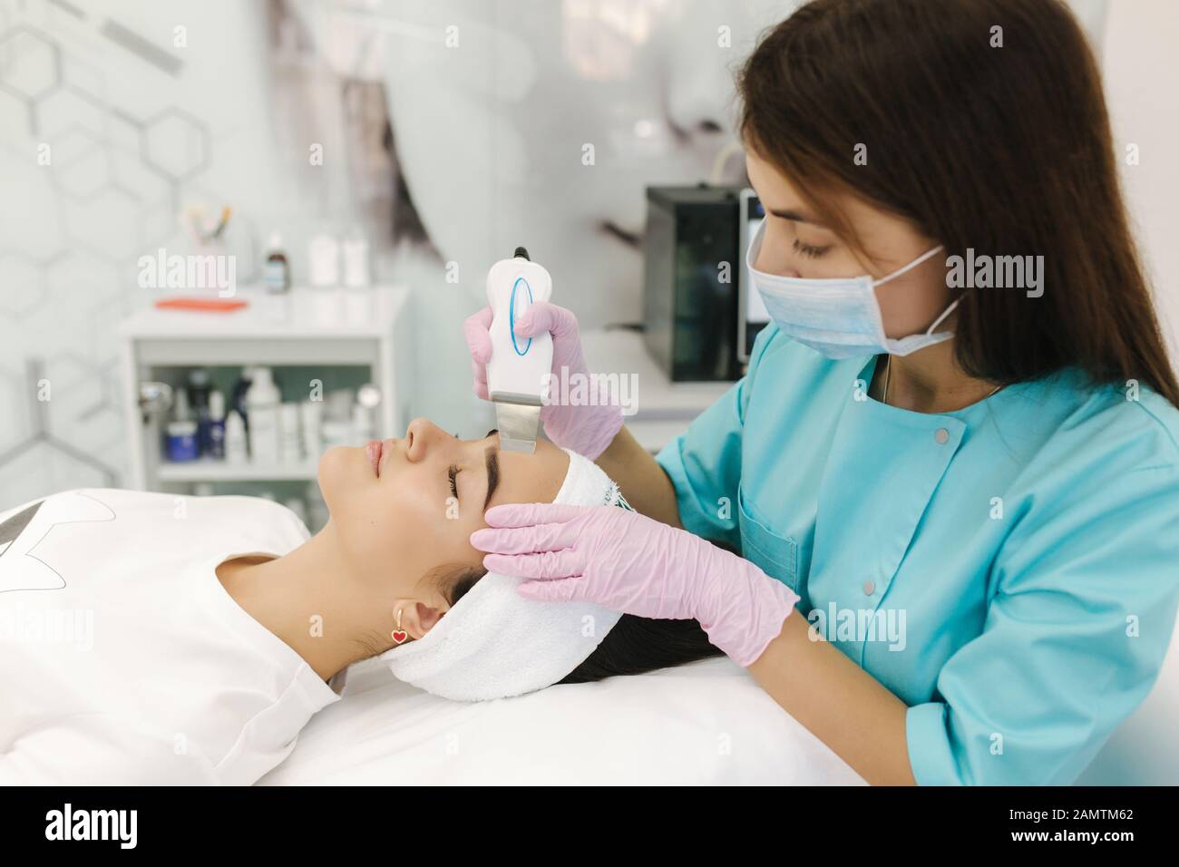 Young woman taking beauty procedure in spa salon Stock Photo - Alamy