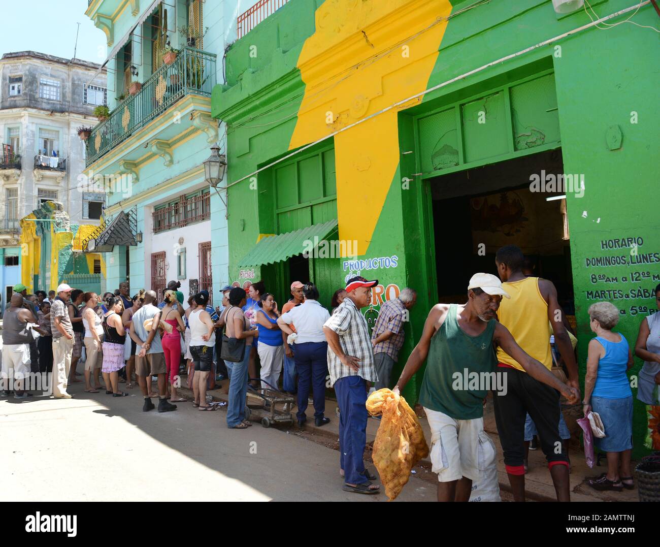 Cubans waiting in line to buy bread as part of ration program by the ...