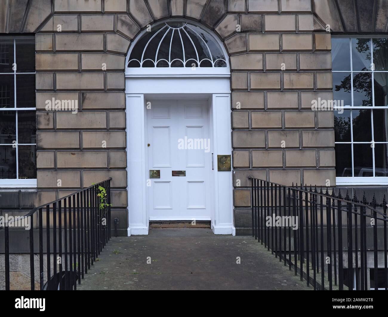 old stone building with white door Stock Photo - Alamy