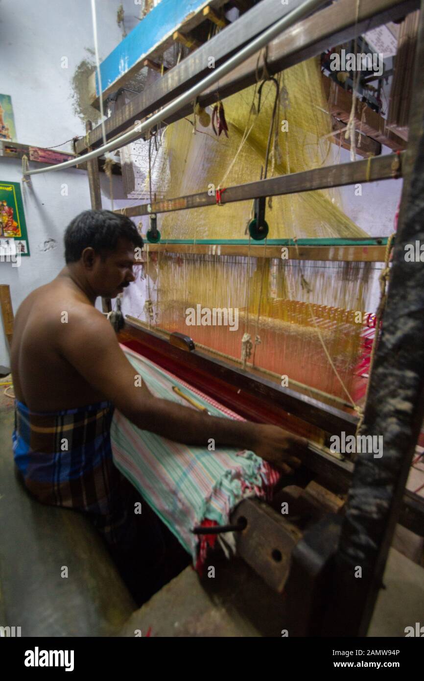 Silk weaver at his loom in his house, weaving Kanchipuram silk sari ...