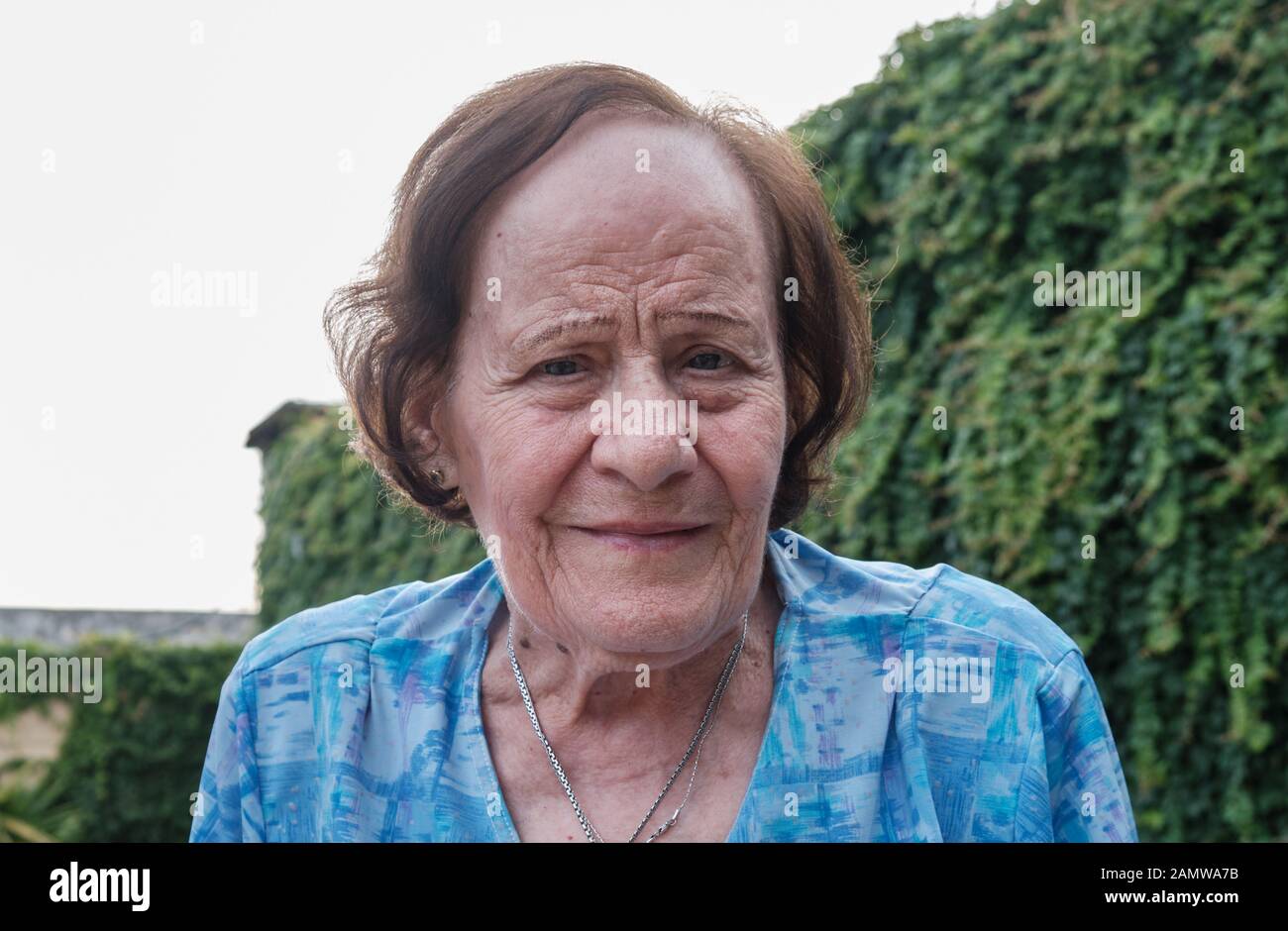 a portrait of an old woman making an expression of quiet and ...