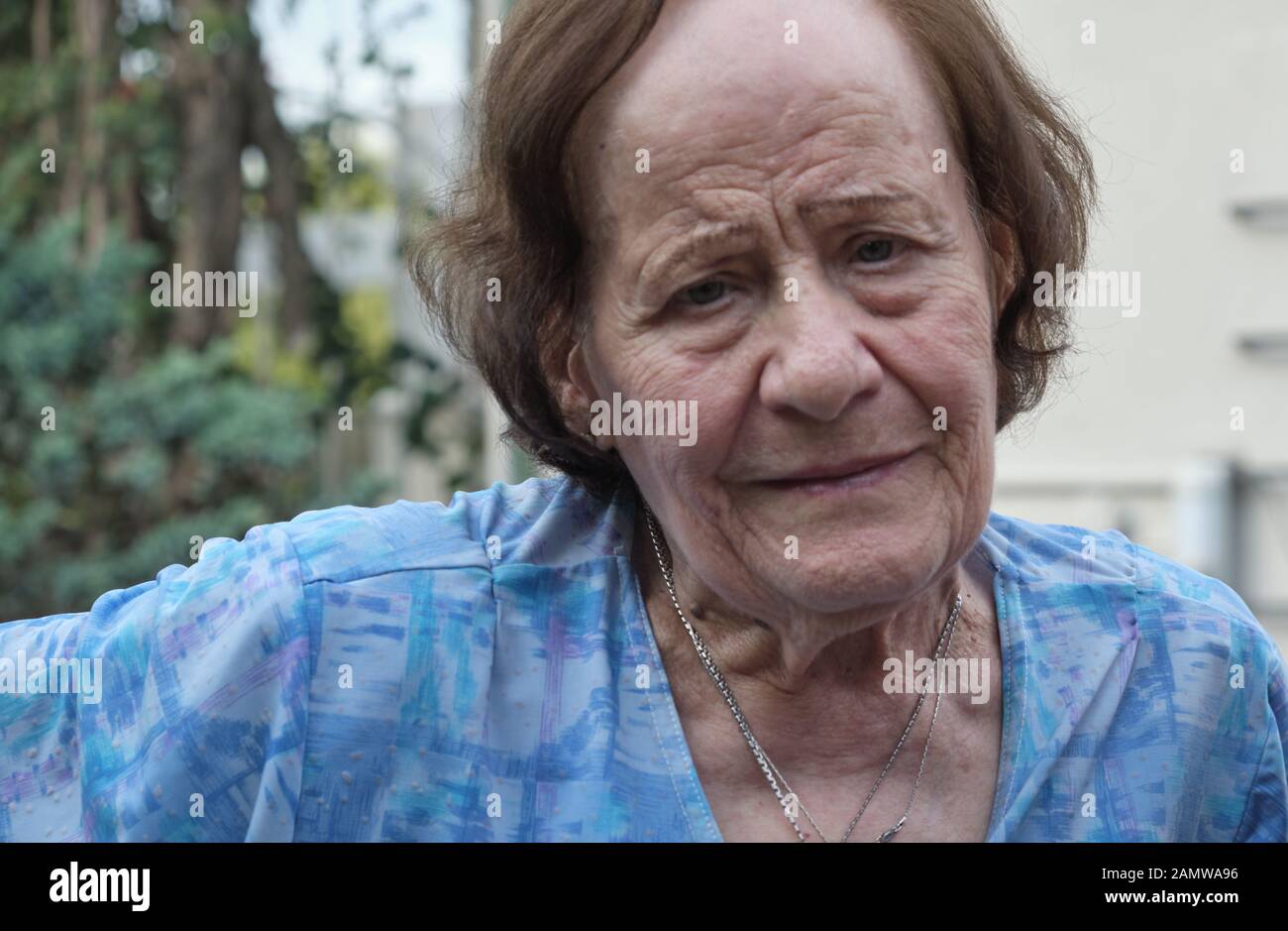 a portrait of an old woman making an expression of quiet and ...