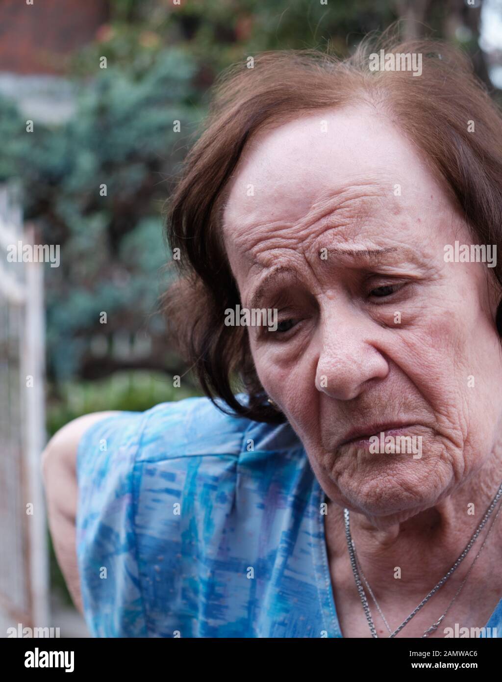 a portrait of an old woman making an expression of concern Stock Photo ...