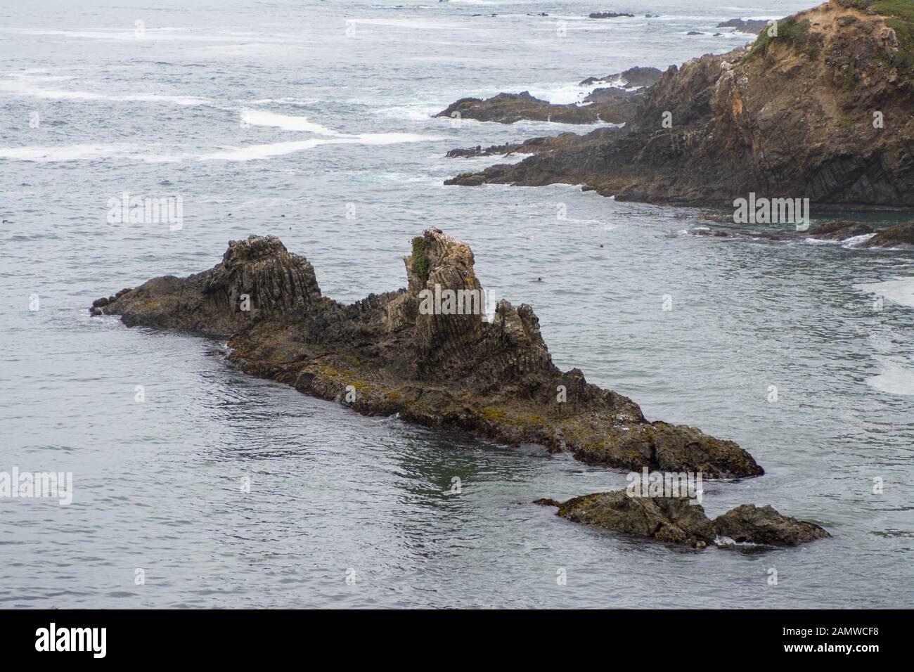 patterned rock outcropping from ocean Stock Photo - Alamy