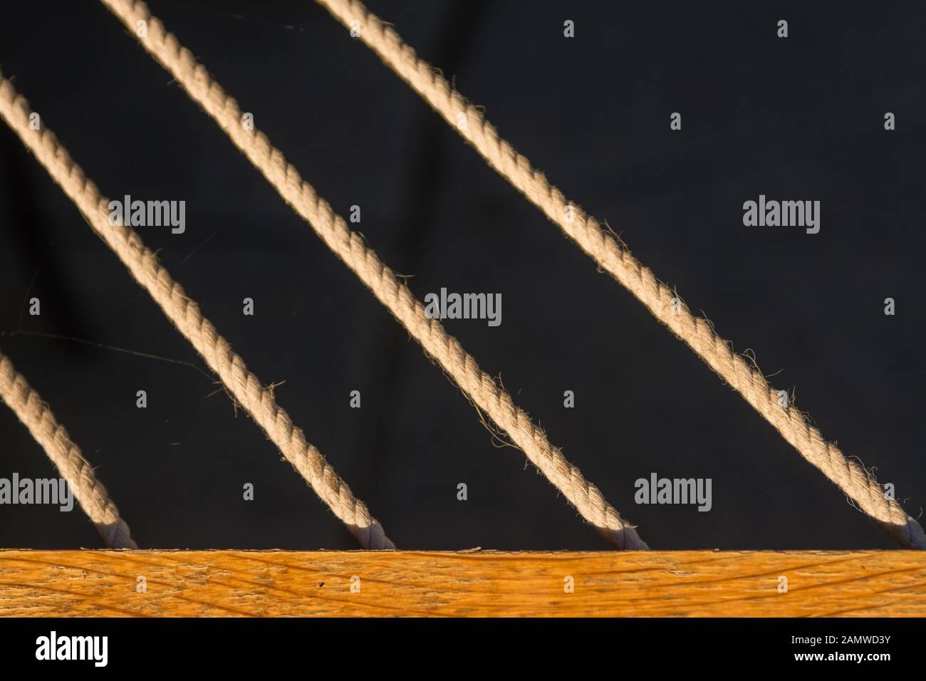 abstract background of ropes tied to wood block Stock Photo - Alamy