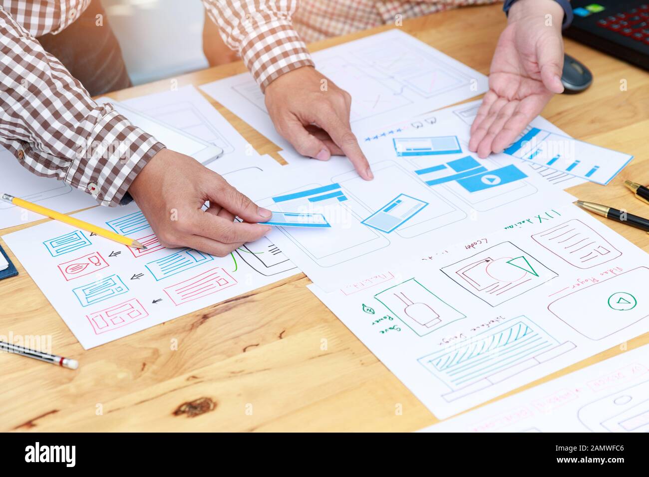 Graphic designers work together with UX UI designer planning ...