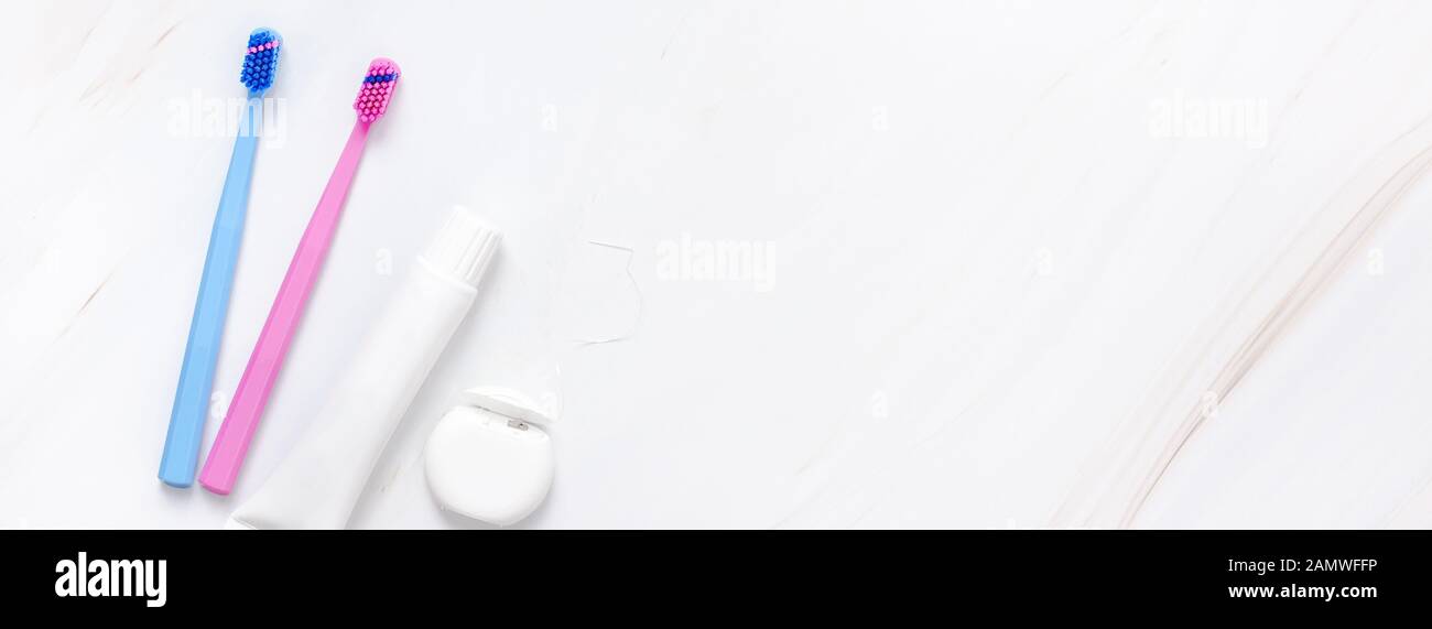 Teeth hygiene and oral dental care products on white marble table ...