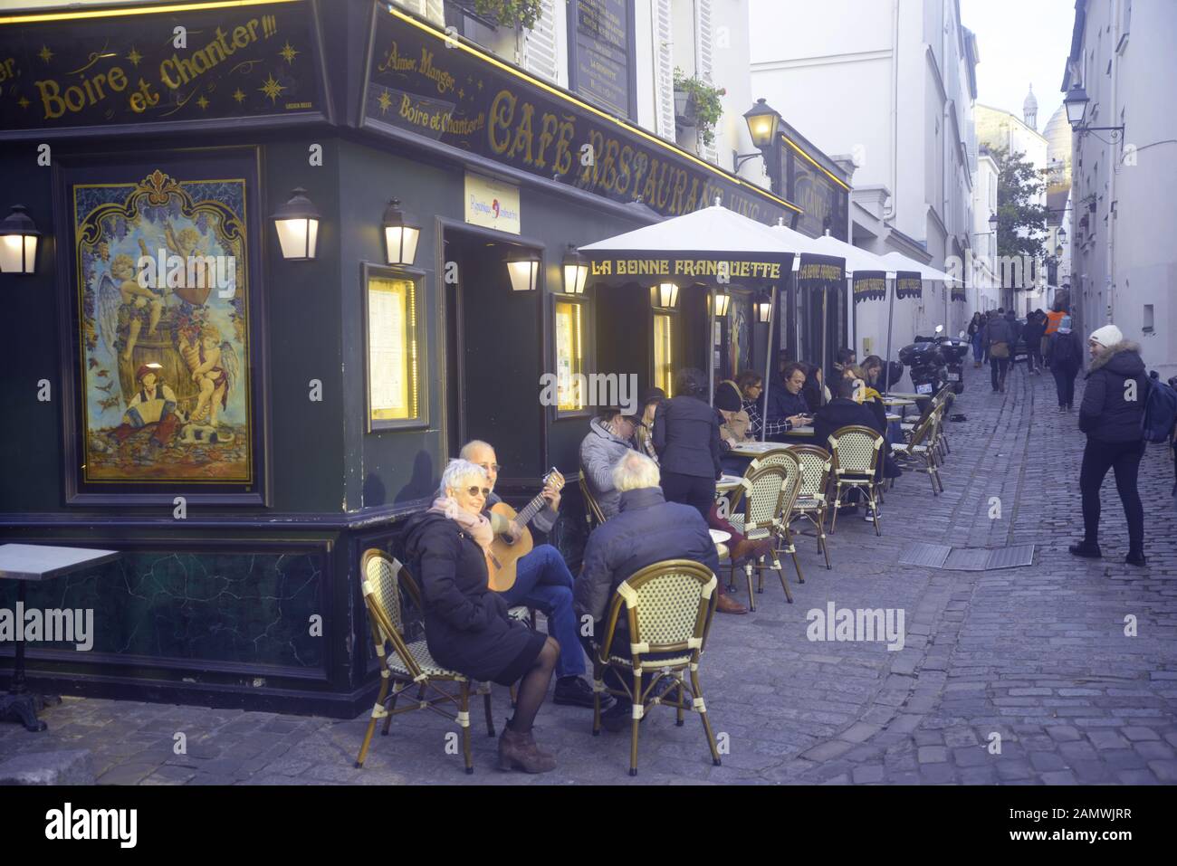 Musician in front of a cafe in Paris, by pasakdek Stock Photo - Alamy