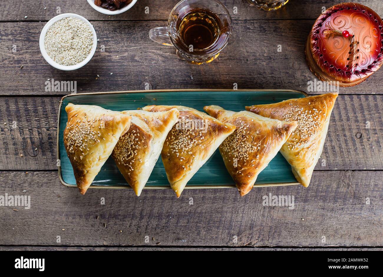 Eastern cuisine. Delicious samosas samsa with meat, glass of tea on ...