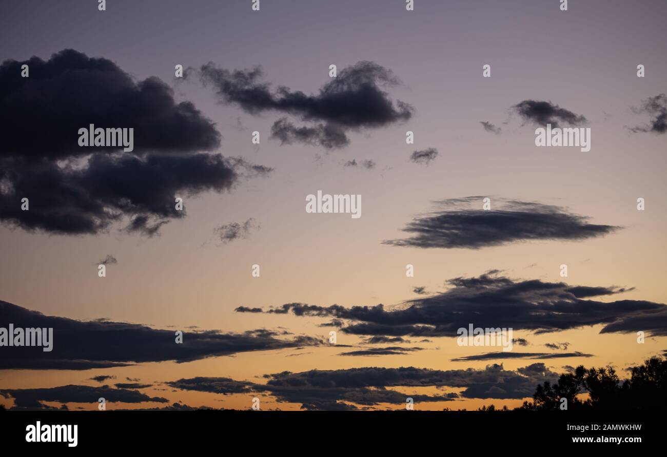 Sunset clouds. Dramatic magical sunrise sunset over orange blue gray ...