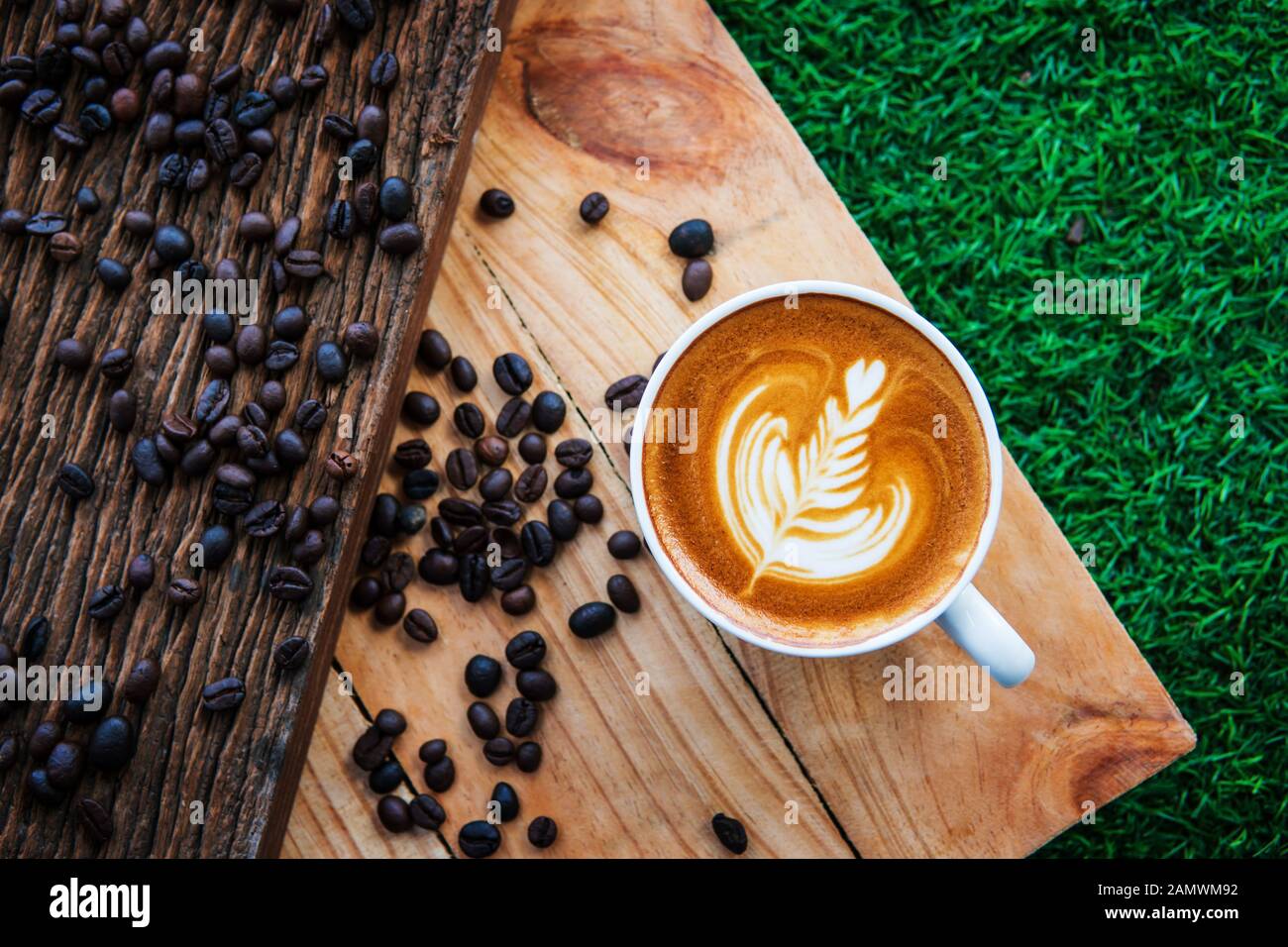 cappuccino coffee and coffee bean on wood texture background. breakfast ...
