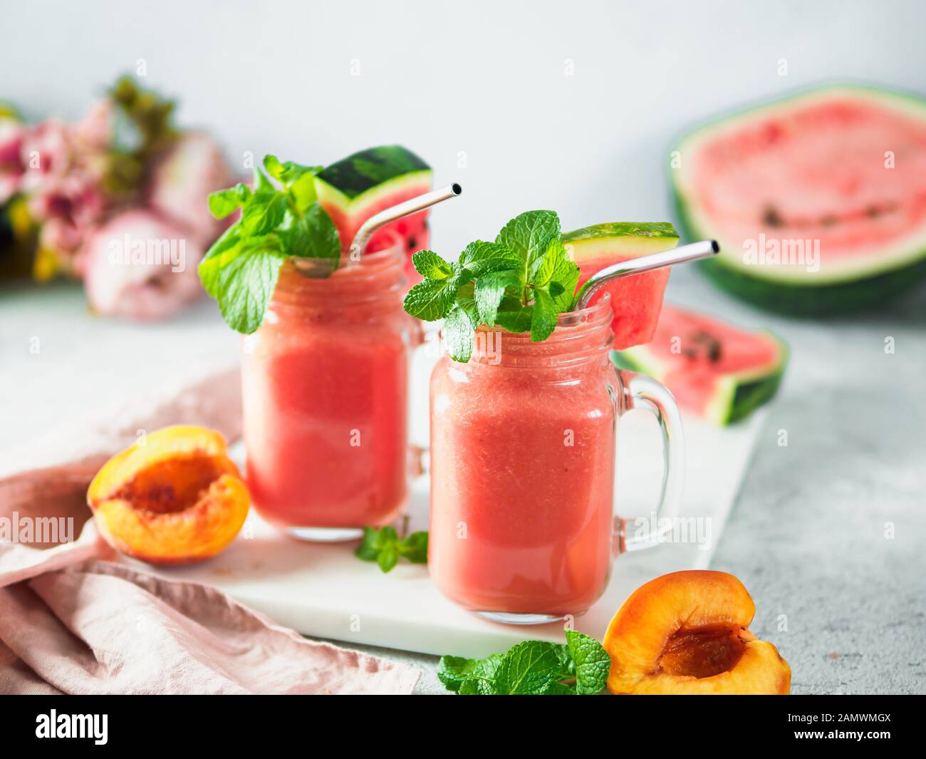 Freshly Blended Watermelon and Peach Smoothies in mason jar and metal ...