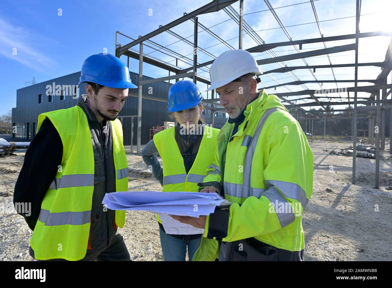 Engineering instructor working on building site with apprentice Stock ...