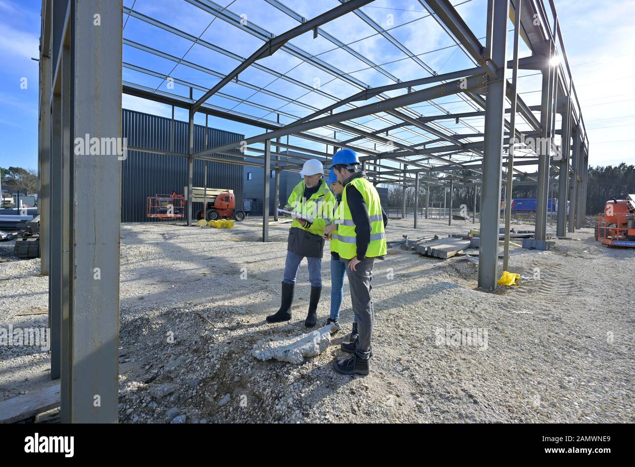 Engineering instructor working on building site with apprentice Stock ...
