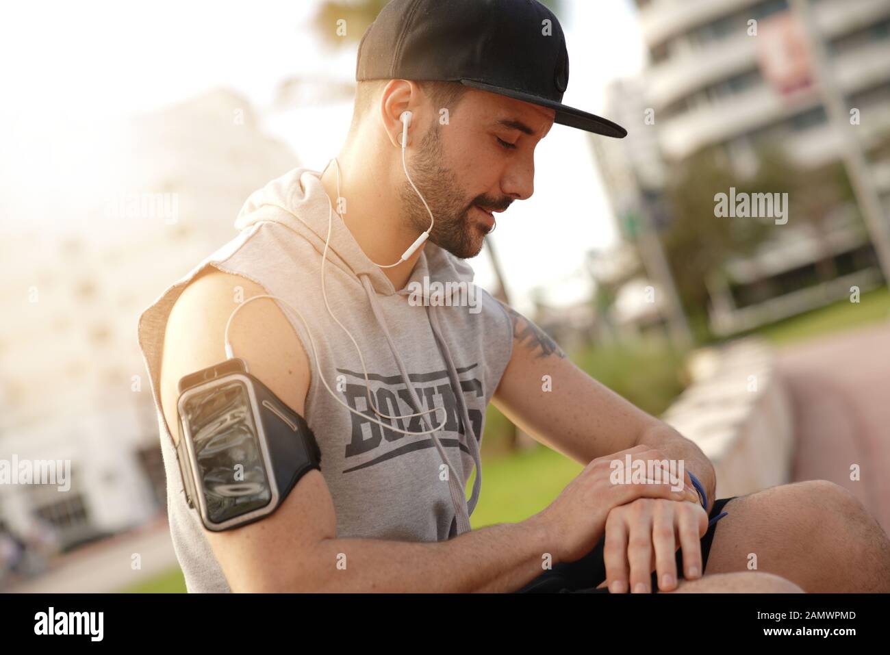 Athletic guy listening to music on workout morning Stock Photo - Alamy
