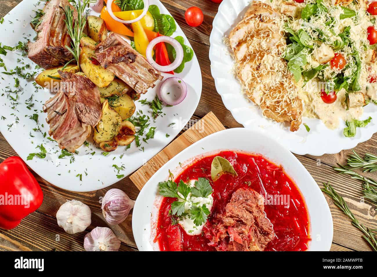 Different dishes on wooden table, top view. Vegetable beet soup, rack ...