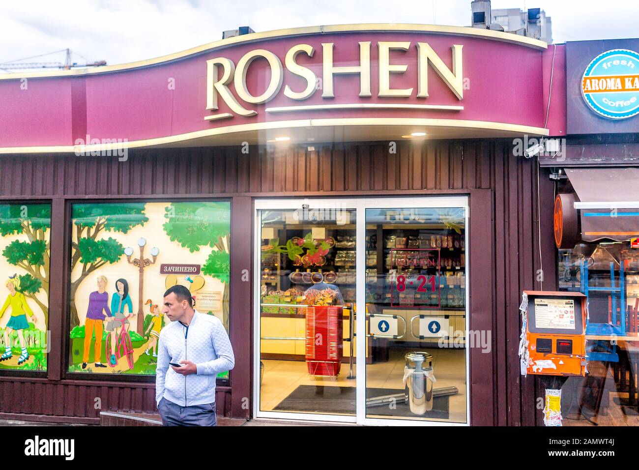 Lutsk, Ukraine - August 21, 2018: Street with people standing by Roshen ...