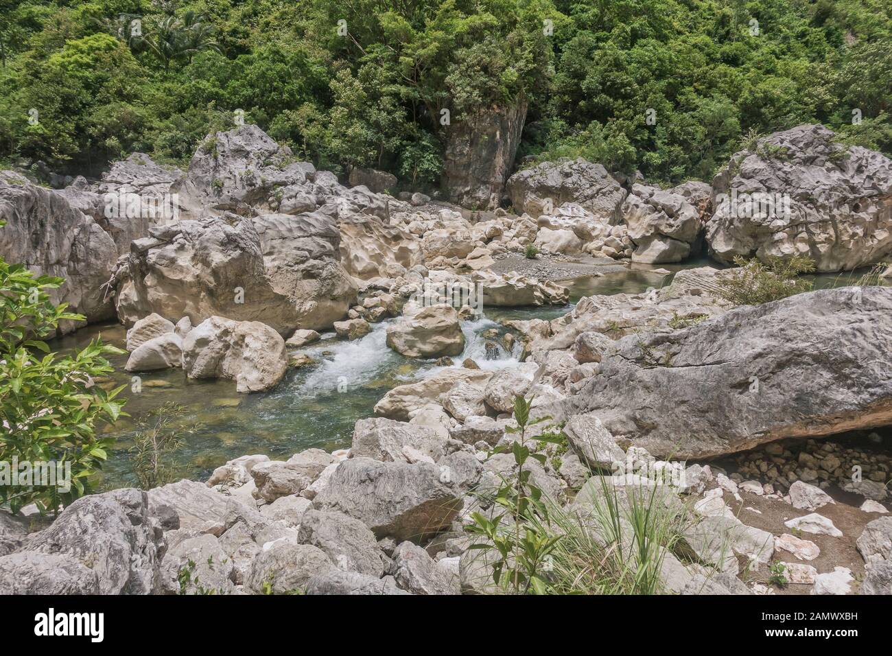Tinipak River flows through mountainous terrain with rapids and cave ...