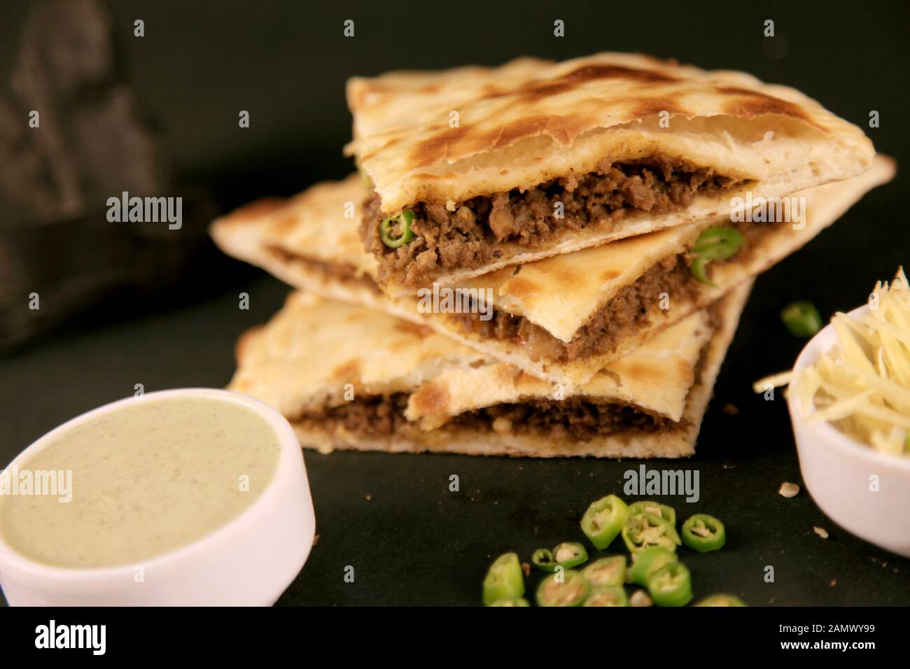 Smoked Minced Meat Stuffed Naan with Green Chillies on Black background ...