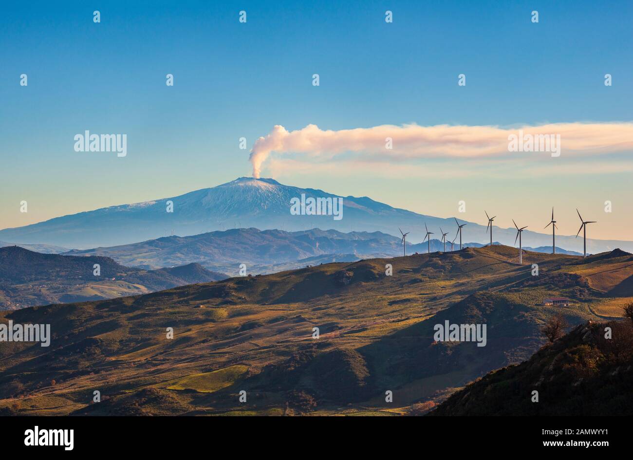 View of windmills and the mount Etna Volcano with smoke. Sicily Stock ...