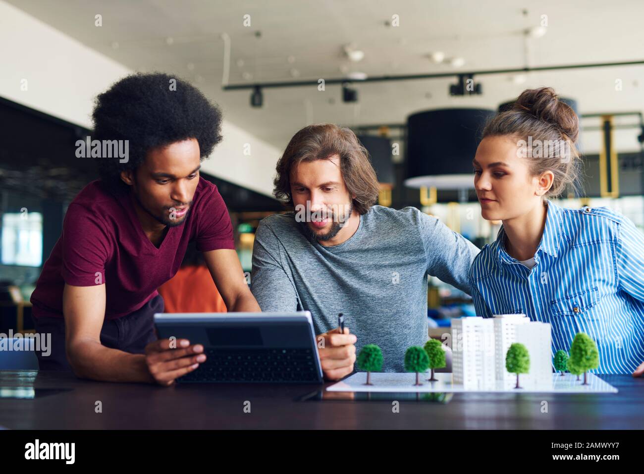 Young adult colleagues working at office desk Stock Photo - Alamy