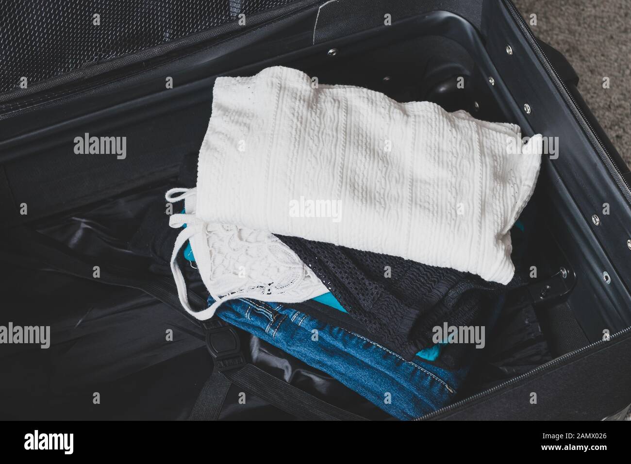 travel essentials and packing for a holiday concept, luggage with pile ...