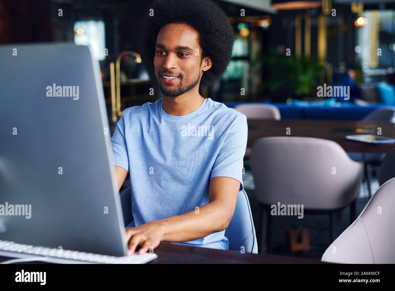 African man working on computer in the office Stock Photo - Alamy