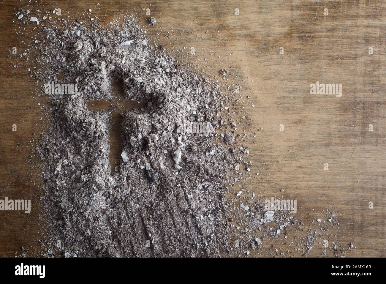Christian cross symbol made of ash on a wooden background Stock Photo ...
