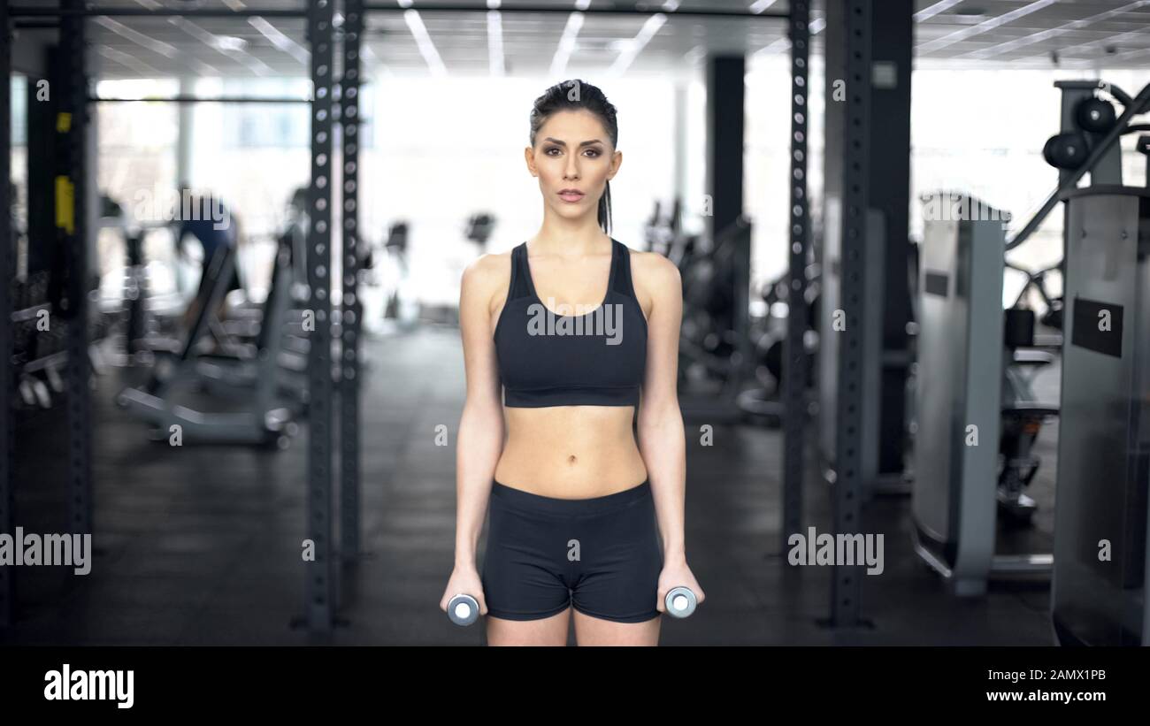 Strong woman training with dumbbells in gym, muscles training, active ...