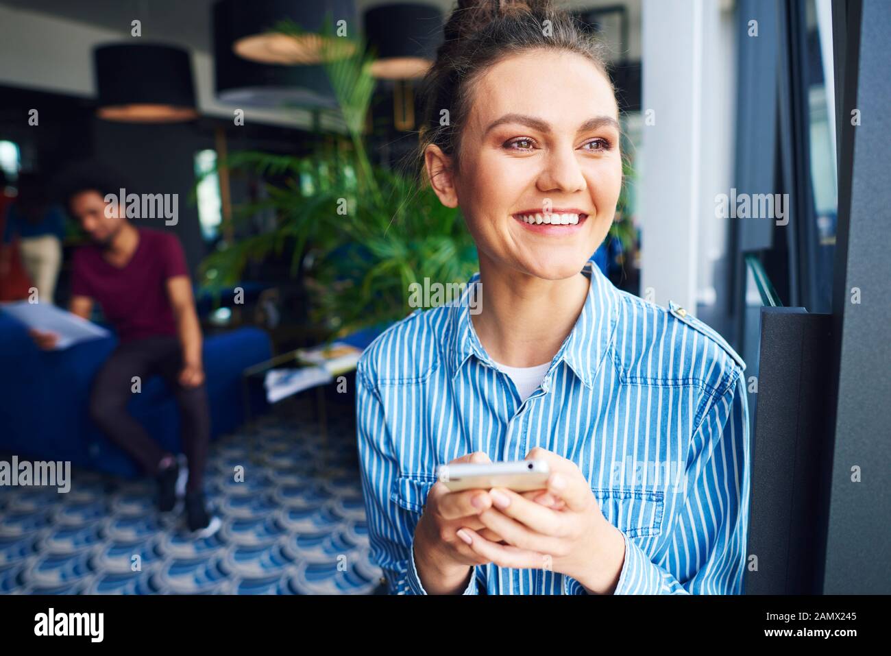 Office worker using the cell phone over work Stock Photo - Alamy