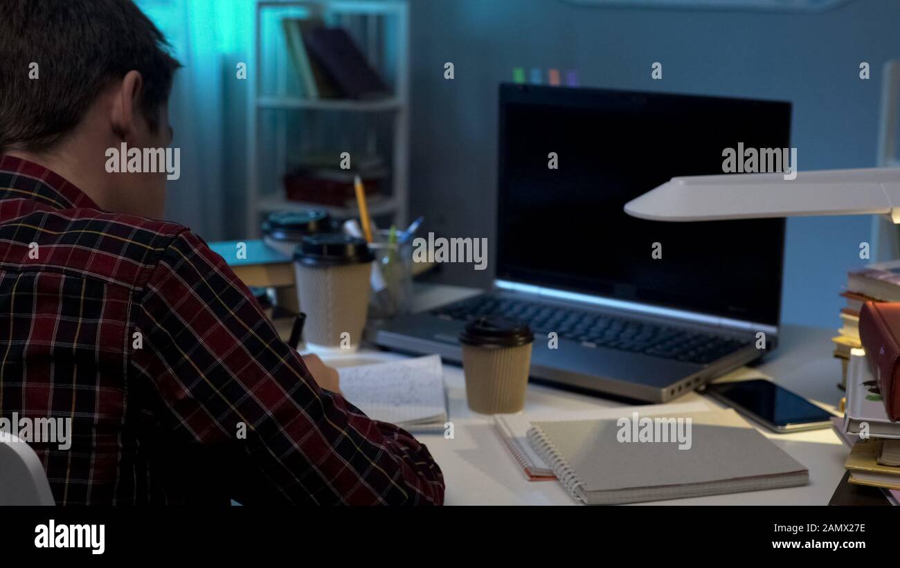 Tired teenager at table hi-res stock photography and images - Alamy