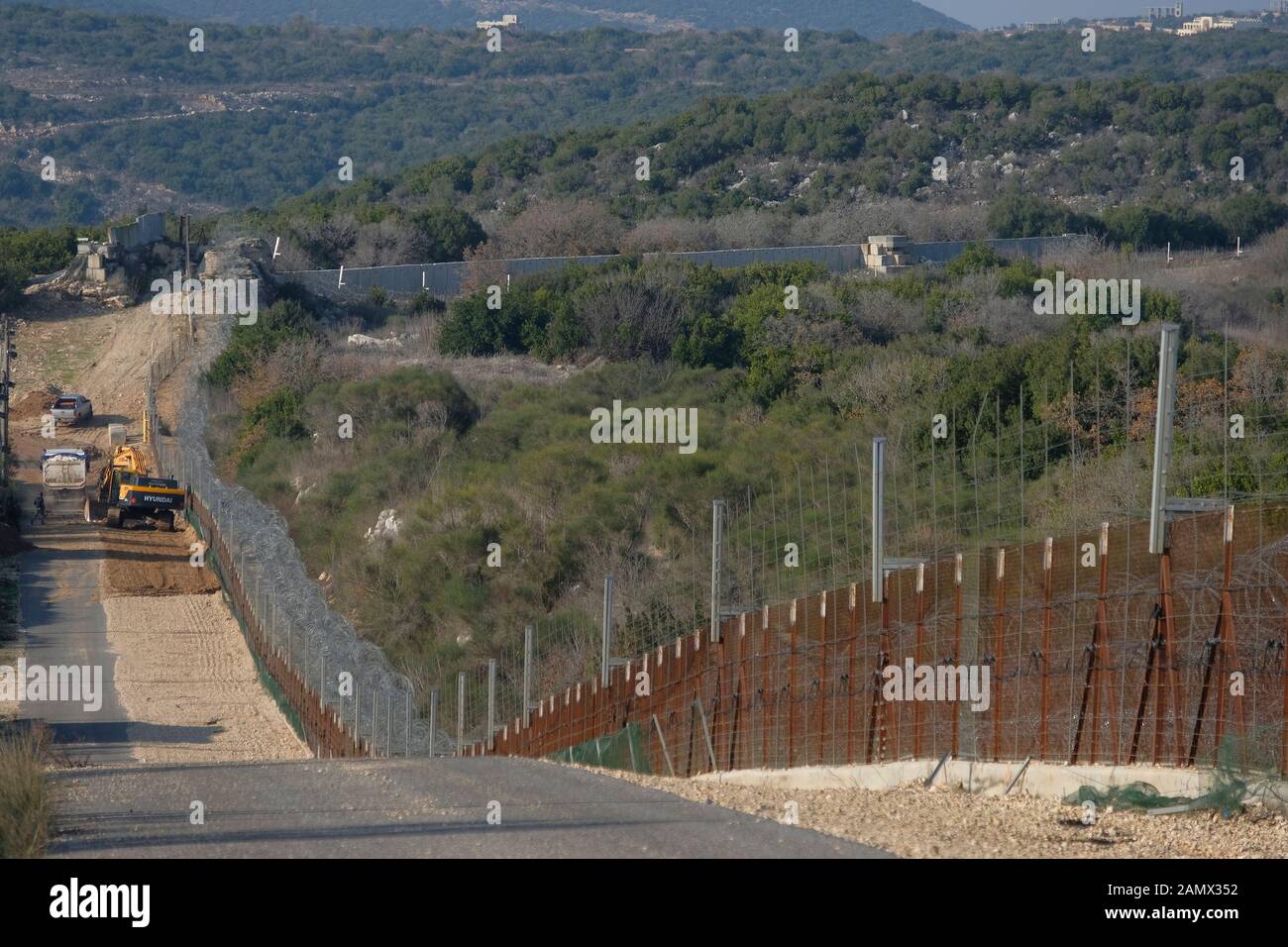 Engineering vehicles level land along the border with Lebanon near the ...