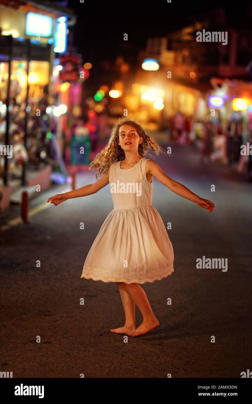 young girl dancing on the street at night Stock Photo - Alamy