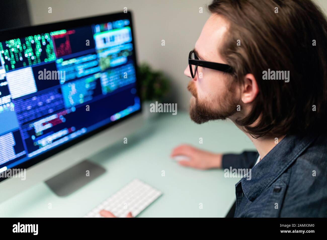 Software developer on the computer screen and is analyzing the code ...
