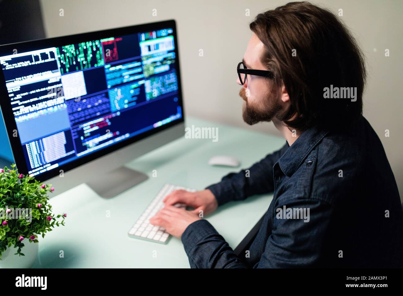 Software developer on the computer screen and is analyzing the code ...