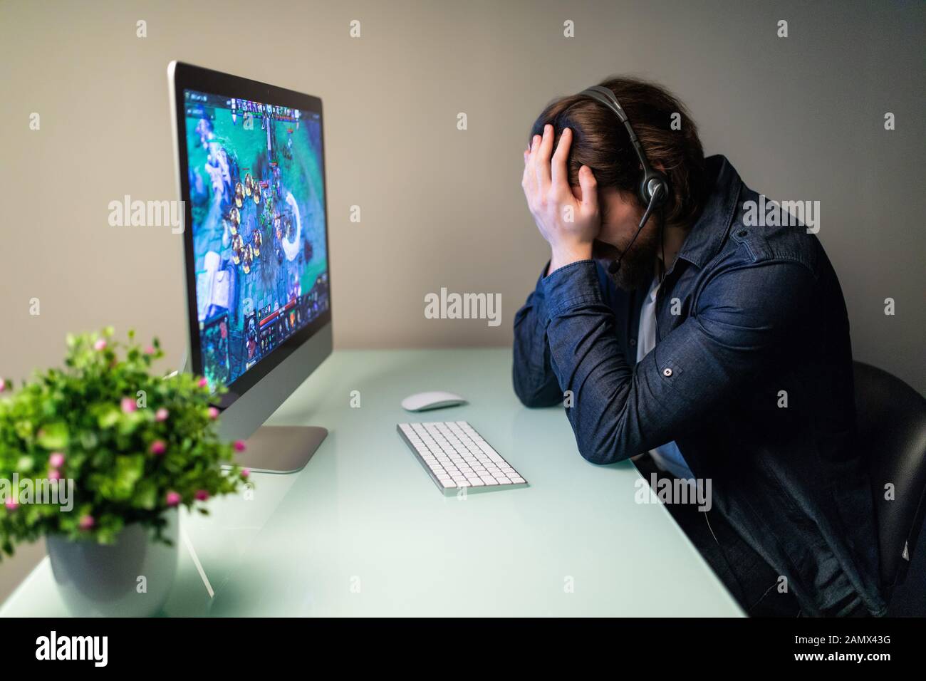 Young gamer playing online video games on computer and feel depressed ...