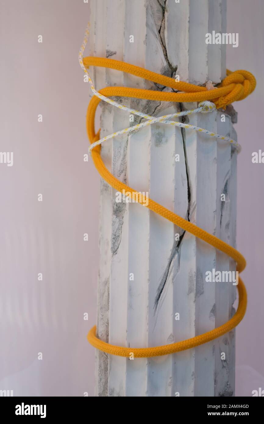 Broken gypsum column tied with cord as a concept of modern art Stock ...