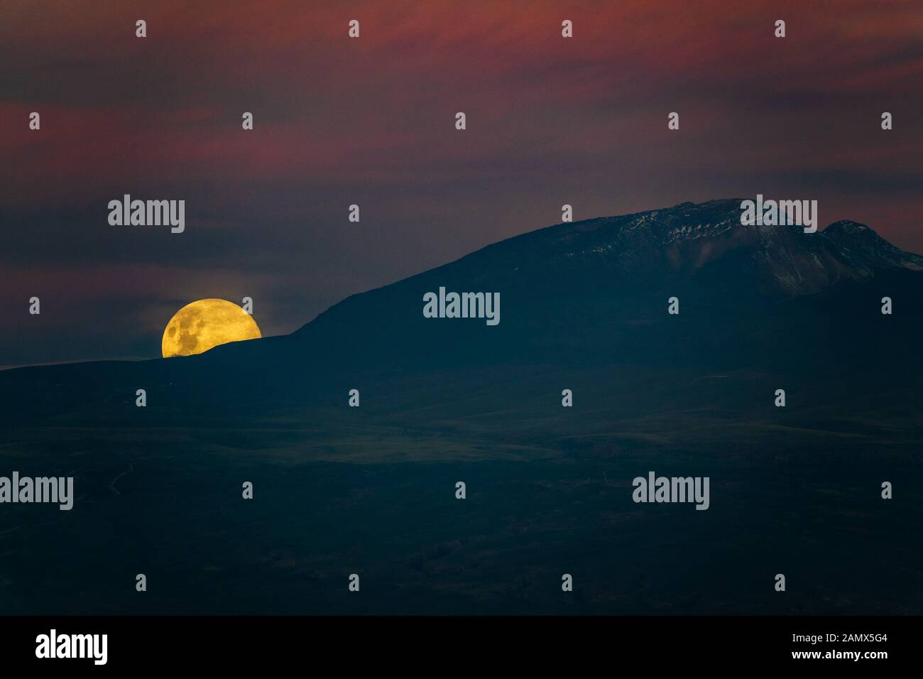 Rising moon behind clouds hi-res stock photography and images - Alamy