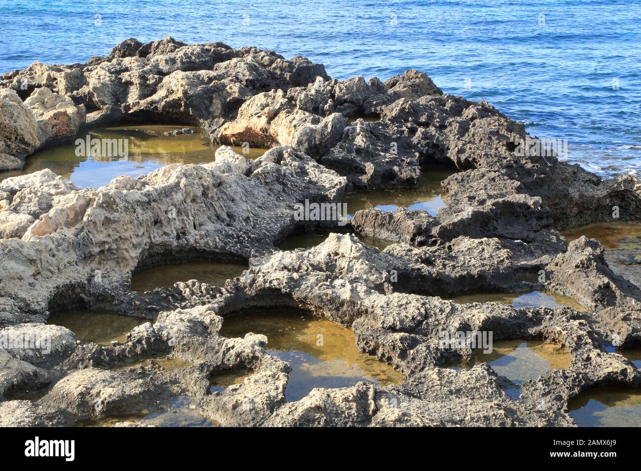 Coral stone on sea coast with rock water pools Stock Photo - Alamy