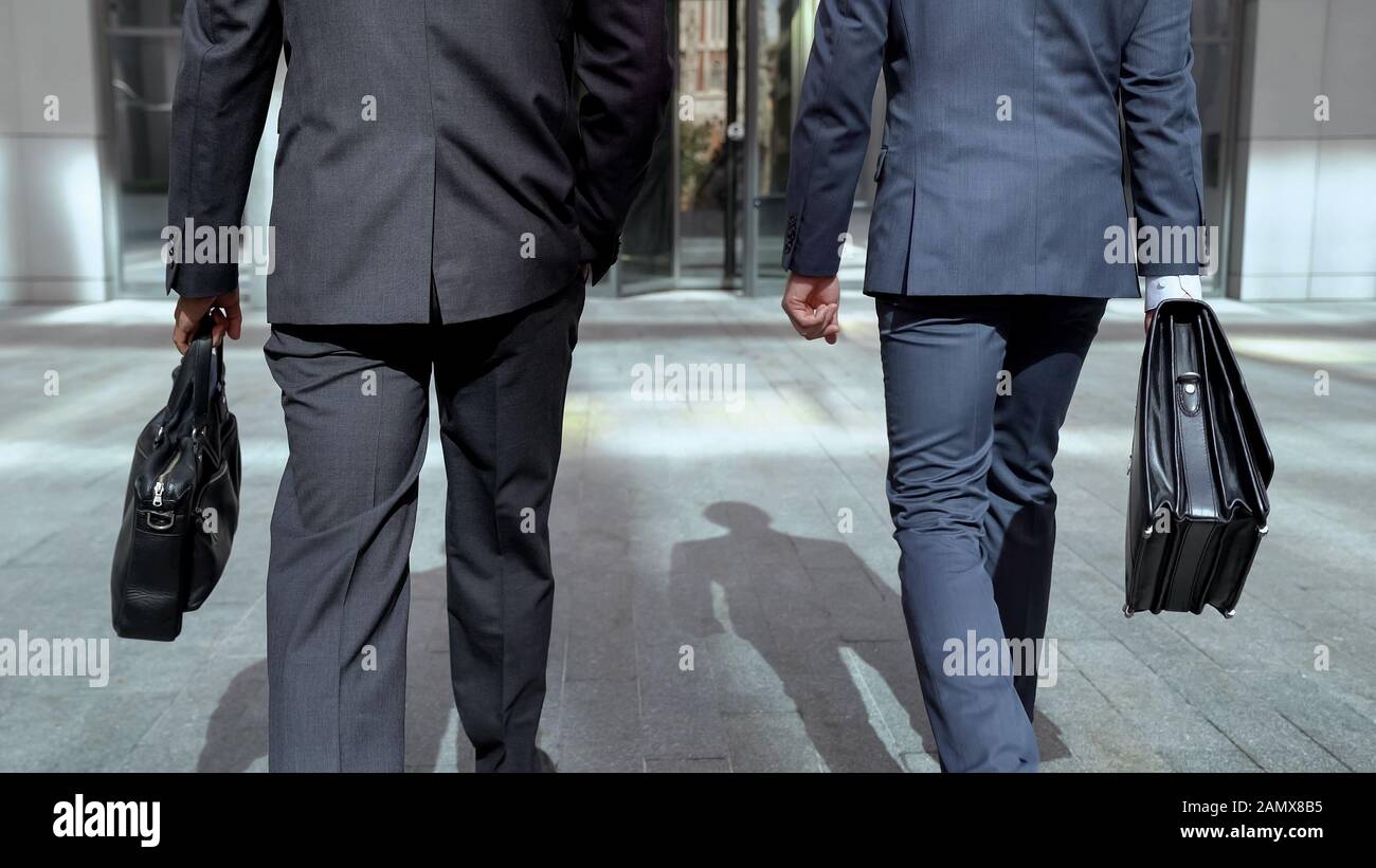 Two businessmen holding briefcases hi-res stock photography and images ...