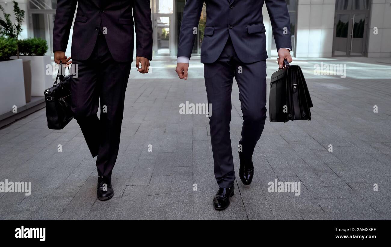 Two businessmen holding briefcases hi-res stock photography and images ...
