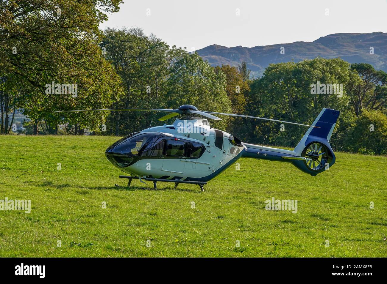 Helicopter landed in the middle of a field Stock Photo - Alamy