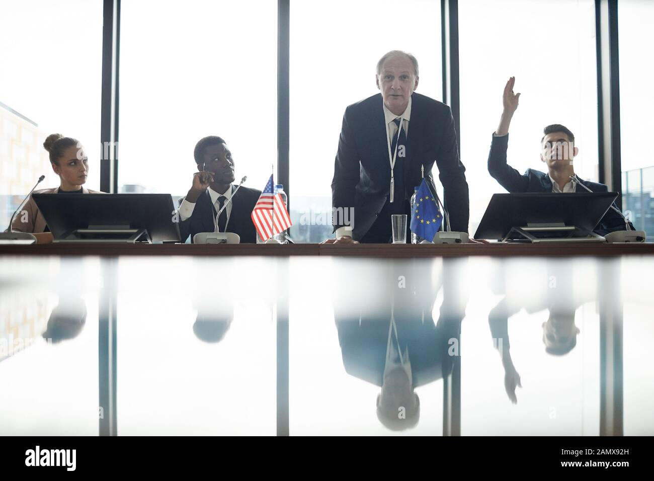 Senior political leader in suit standing and talking during political ...