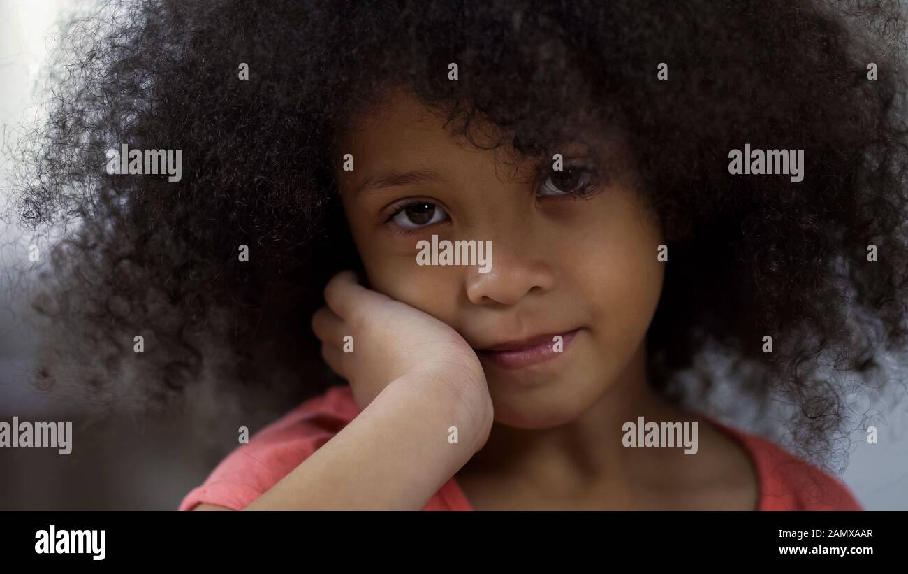 Sweet African girl looking to camera, positive emotions, childhood ...