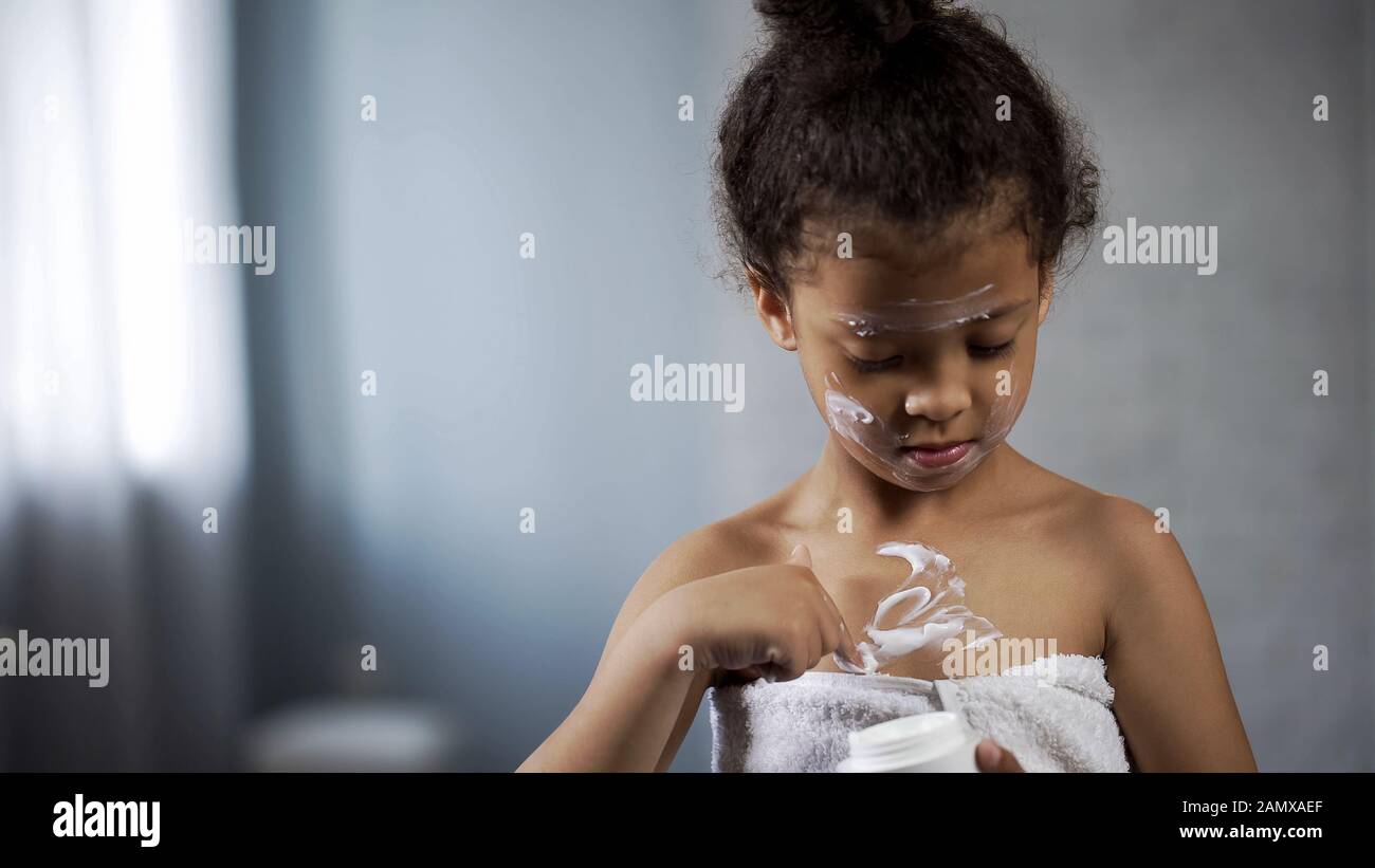 African american putting lotion on hi-res stock photography and images ...