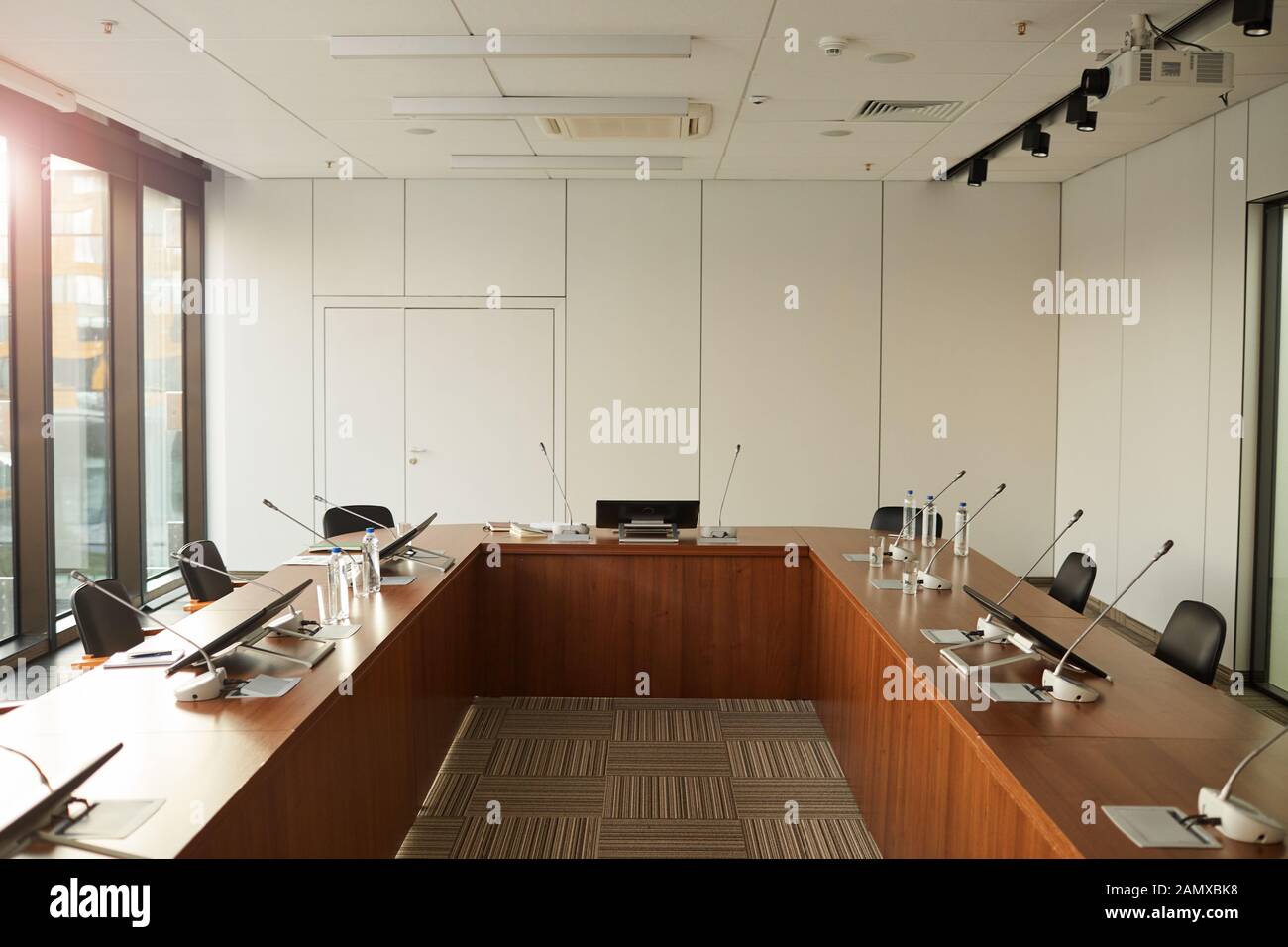 Image of big table with monitors and microphones for speakers in ...
